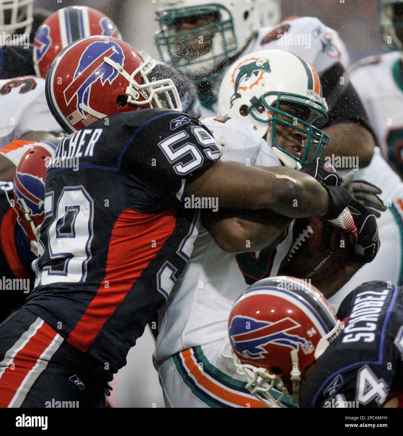 Miami Dolphins' Sammy Morris (31) is tackled by Buffalo Bills' London ...