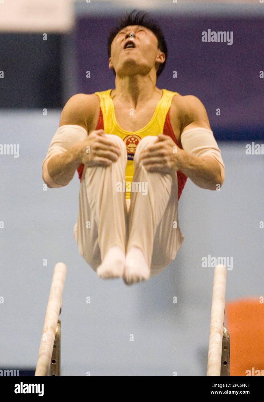 China's Li Xiaopeng performs to win the gold medal of the parallel bars ...