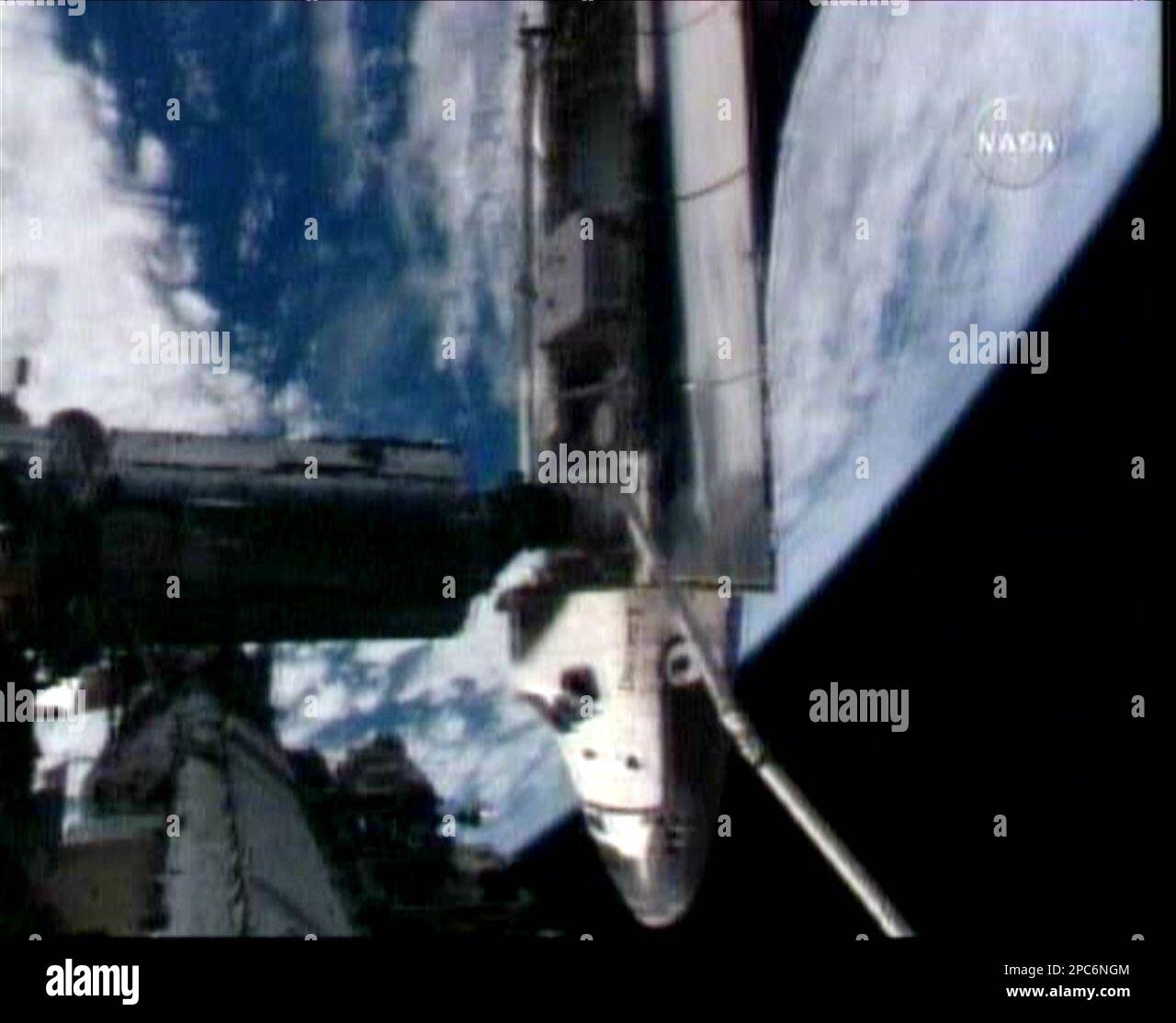 In this image from NASA Television, the Space Shuttle Discovery, docked ...