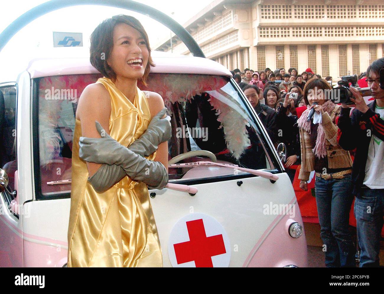 Famed Hong Kong singer Gigi poses for photographers during an event to ...