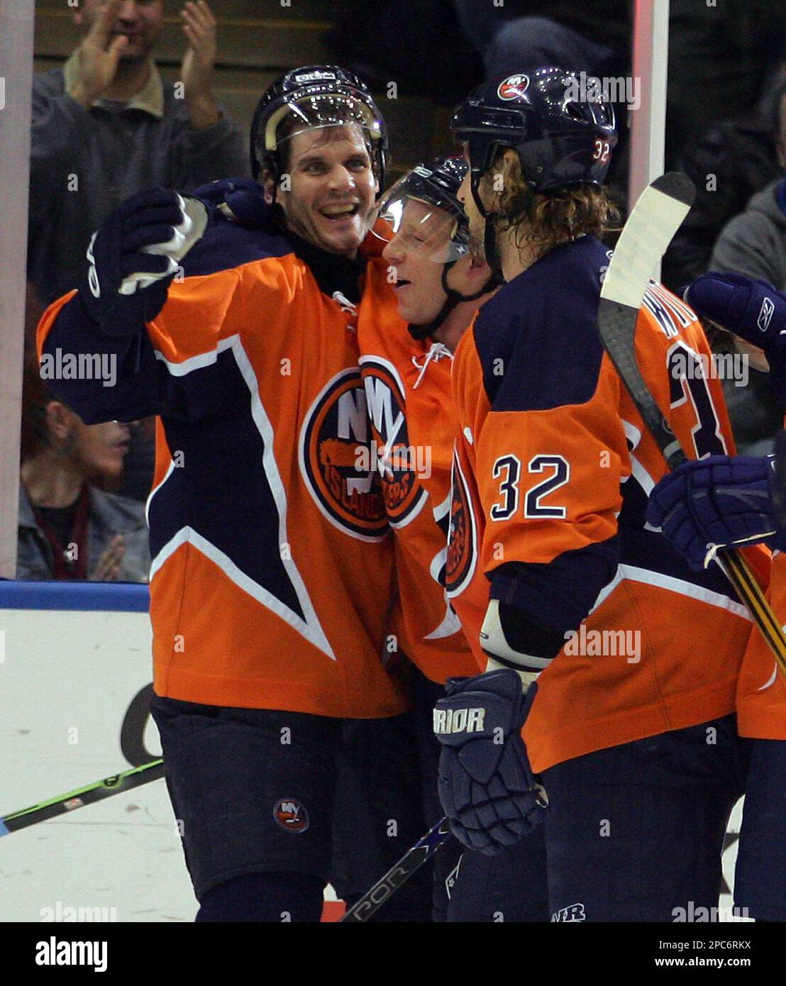 New York Islanders' Alexei Yashin, left, is congratulated by teammates ...