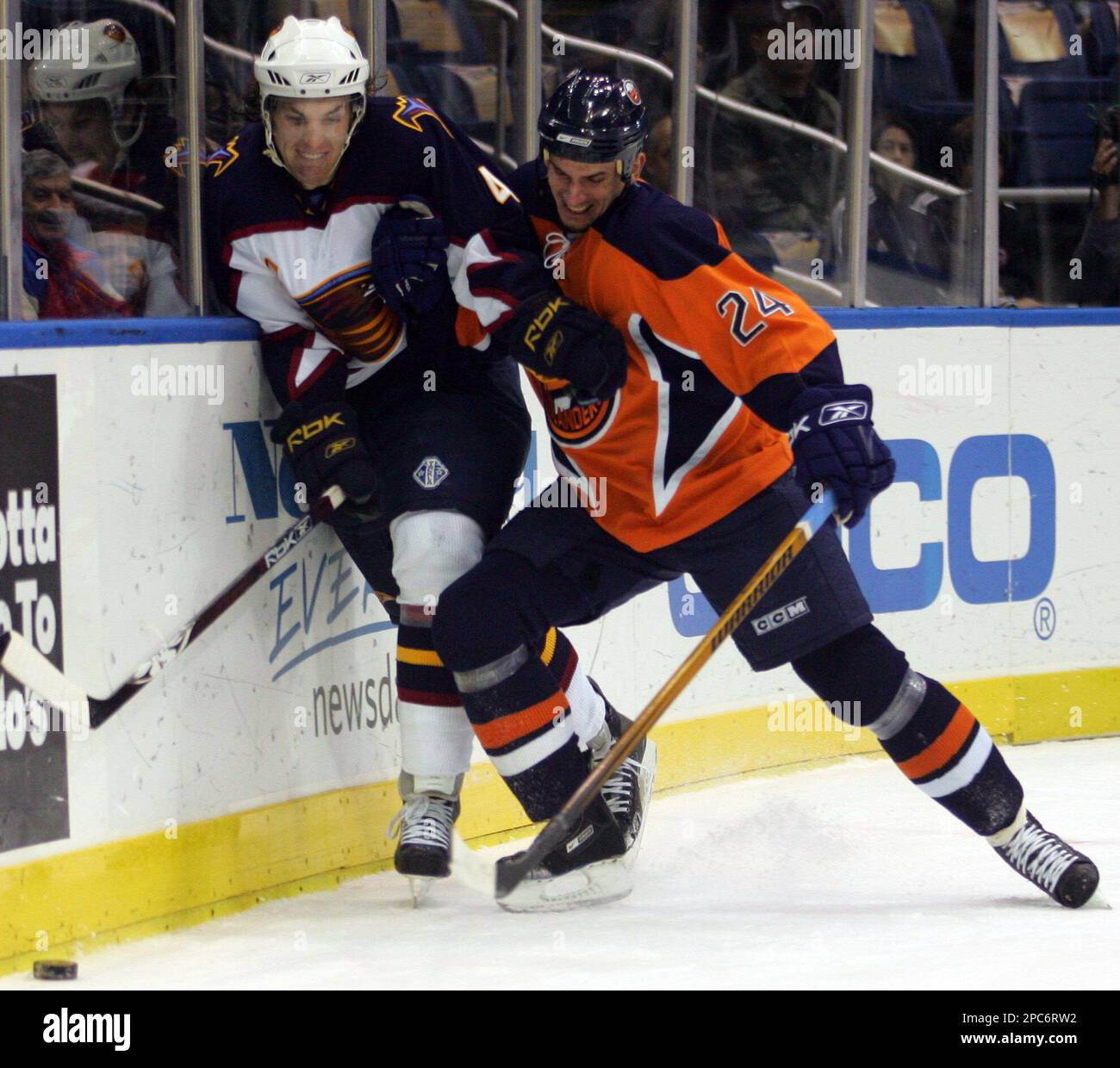New York Islanders' Radek Martinek, right, battles for the puck with ...
