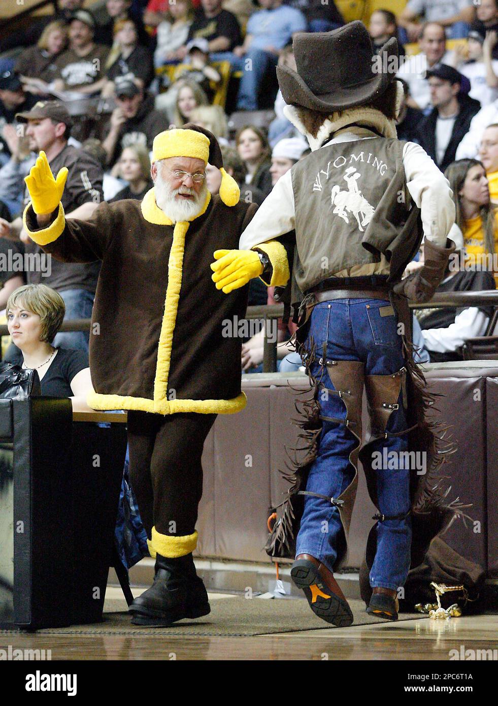 While dressed as a brown and gold Santa Claus, Don Slaughterbeck dances ...