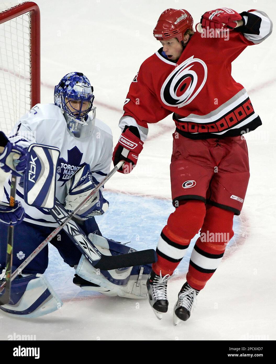 Carolina Hurricanes' Eric Staal (12) avoids the puck as it is caught by ...