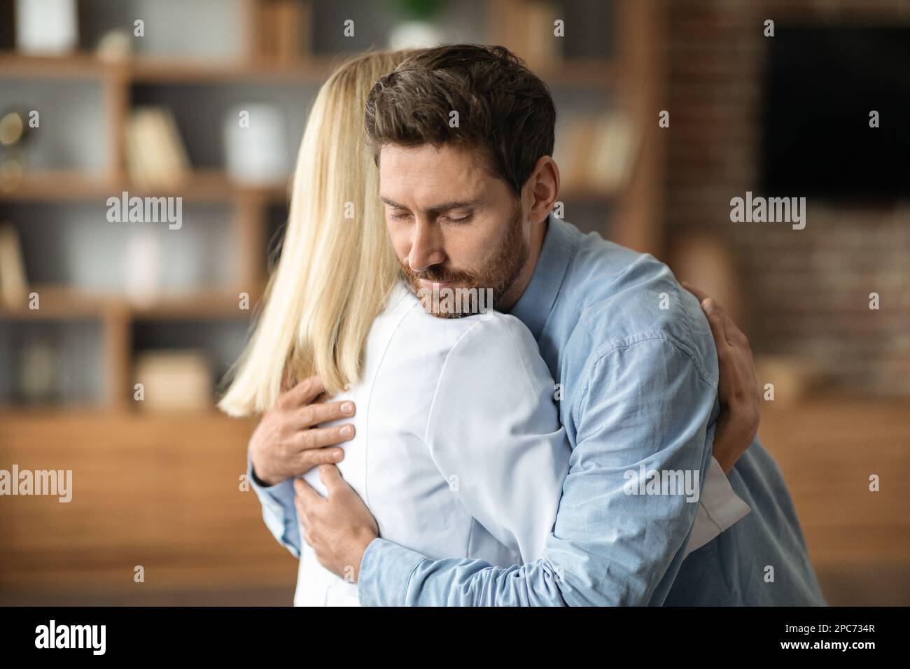 Grateful Patient. Young Man Hugging Doctor Woman During Meeting In ...