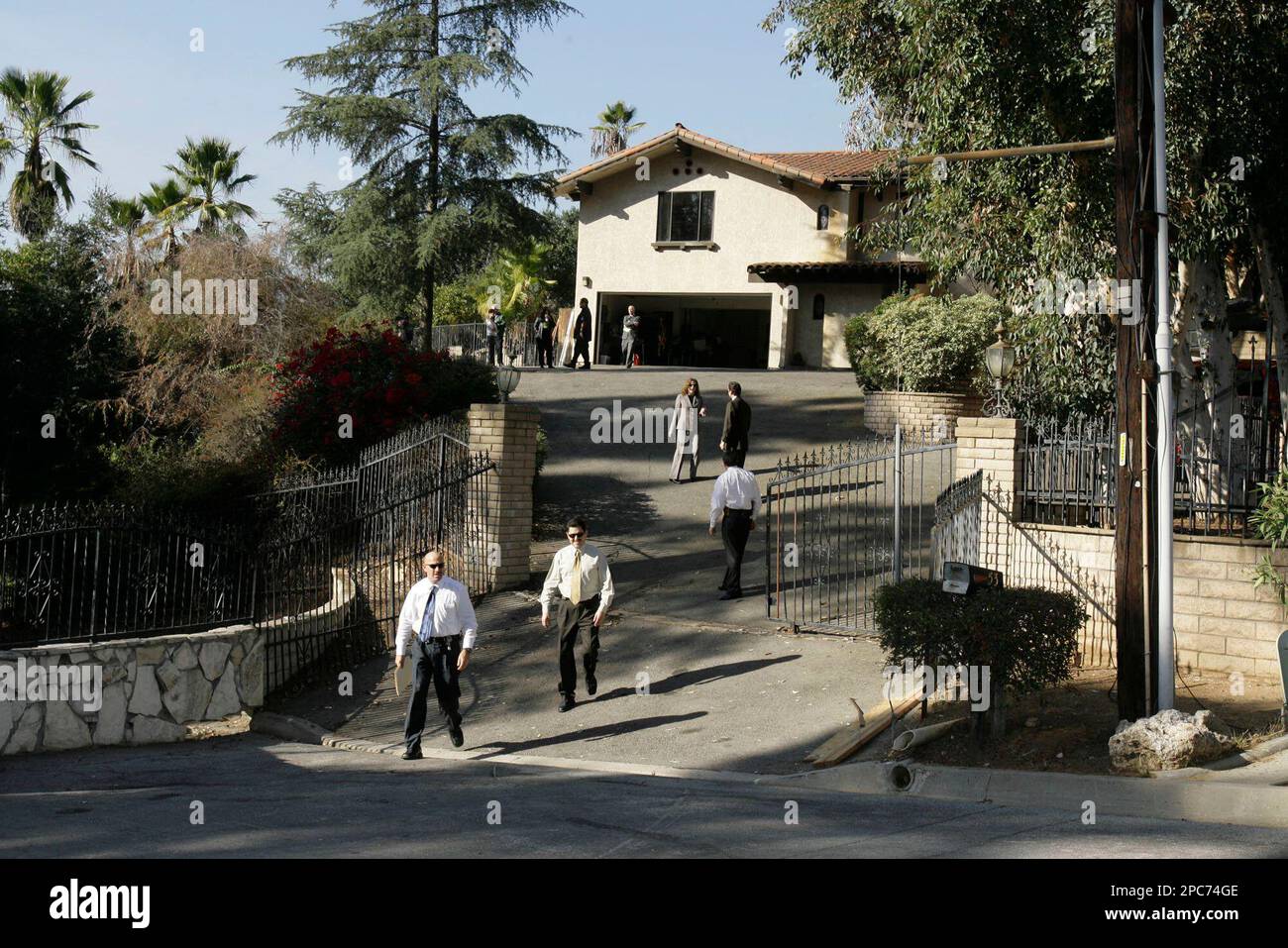 Sheriffs deputies are shown outside the home of racing legend Mickey ...