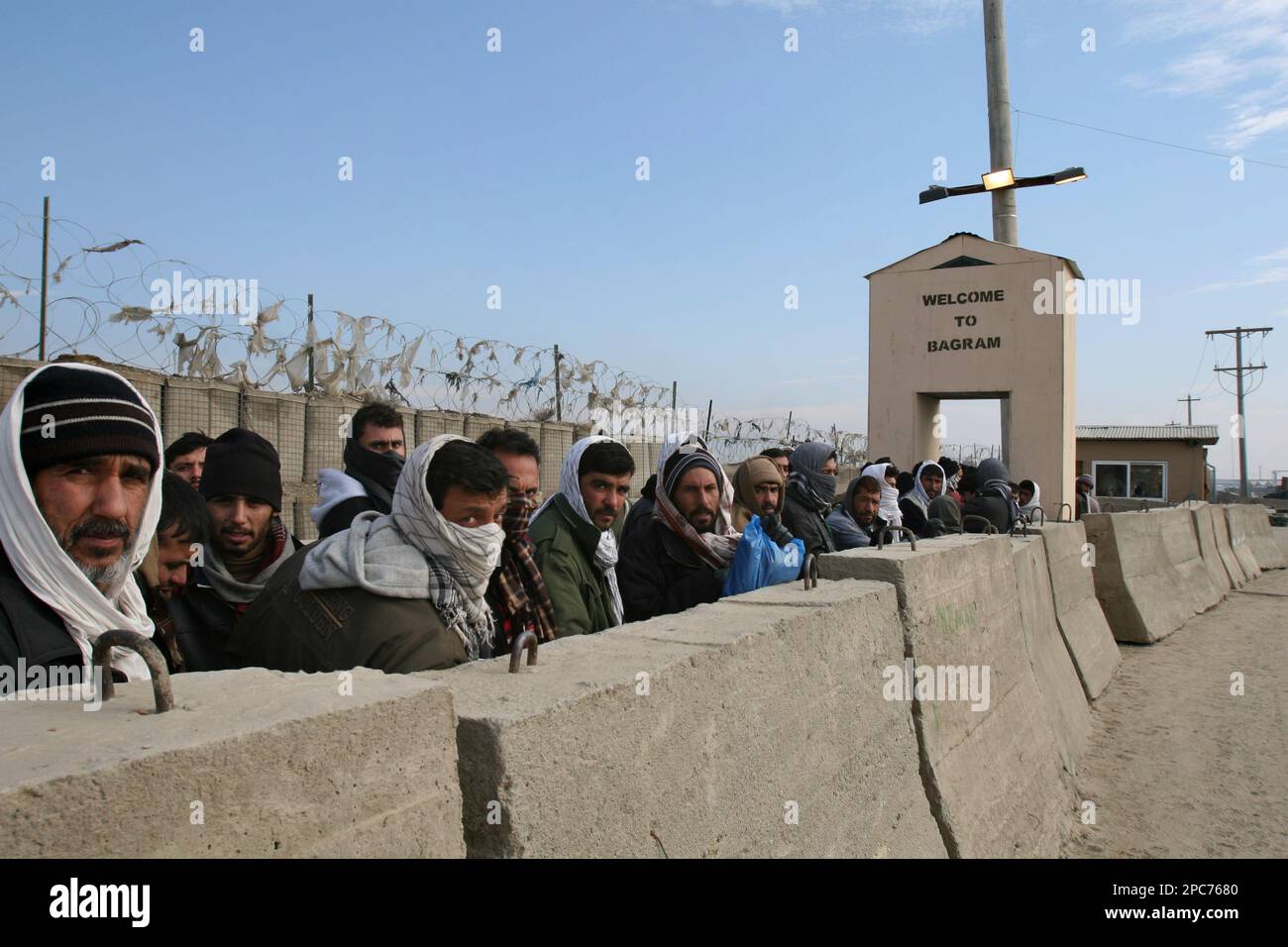 Afghans queue before starting their work inside the main U.S. military ...