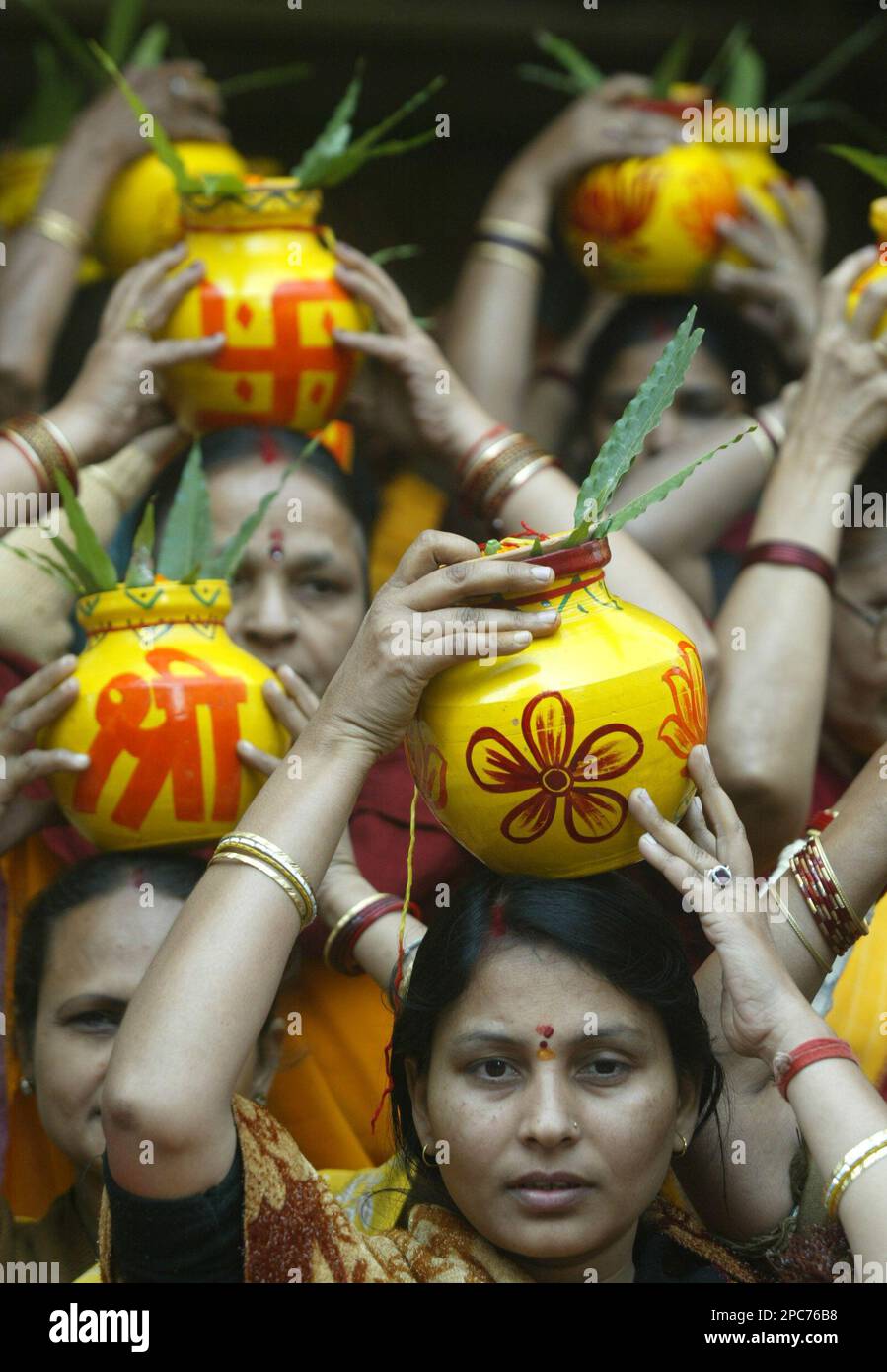 Indian Hindu women devotees carry pots containing Ganges water during a ...
