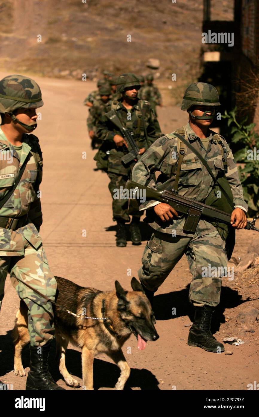 Mexican army soldiers patrol the streets of Aguililla, Mexico in the ...