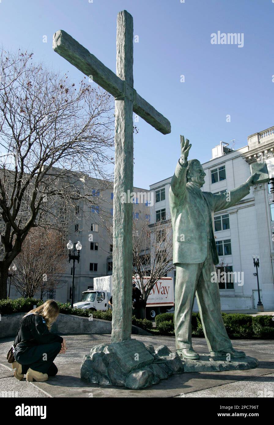 Evelyn Lee Foley prays by the bronze statue of evangelist Billy Graham ...