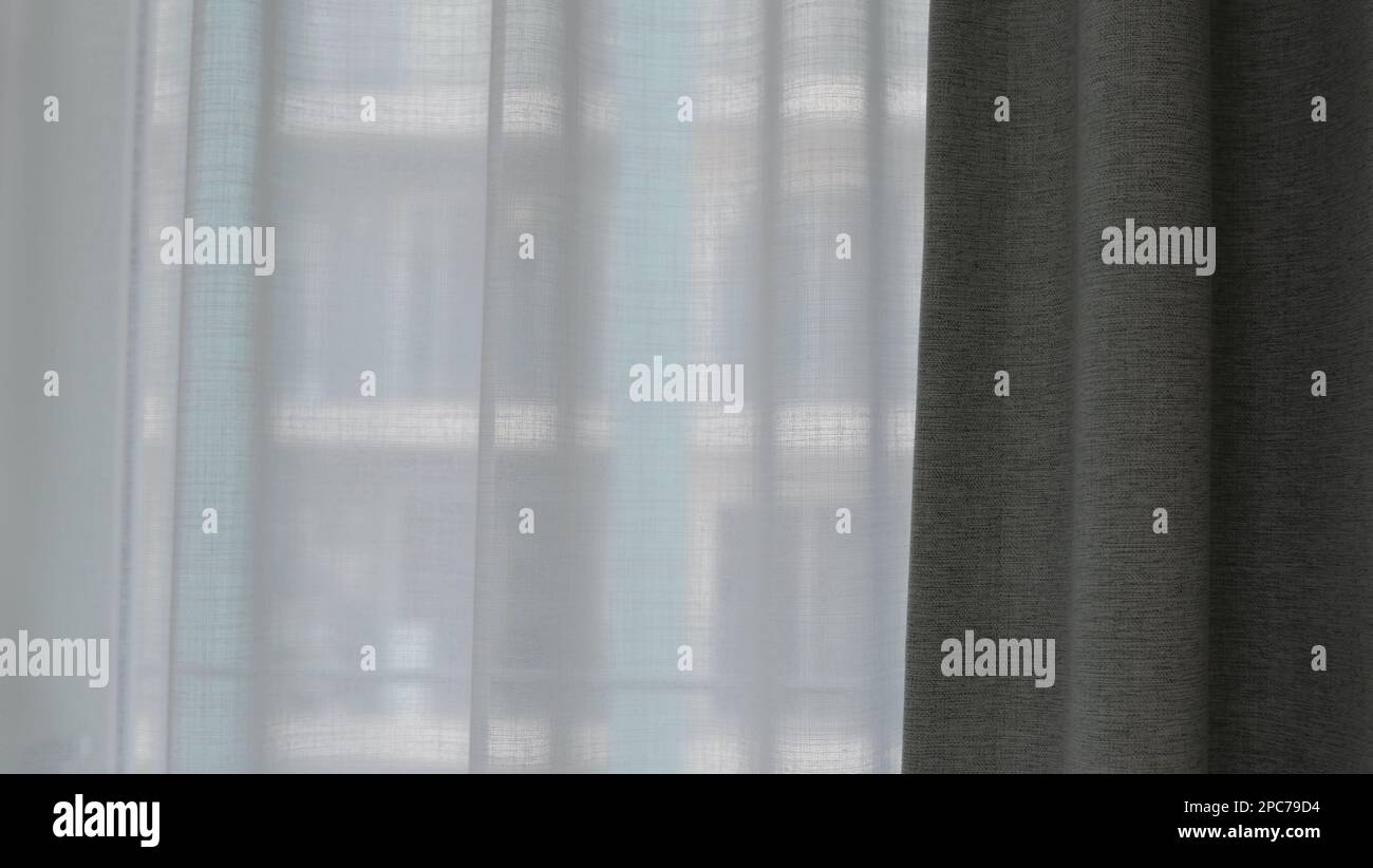 Voile curtain in front of window with dark grey curtain to side Stock ...
