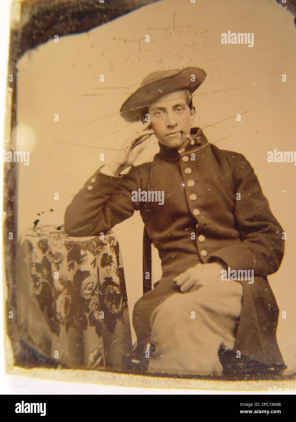 Unidentified young soldier in Union frock coat and slouch hat smoking ...