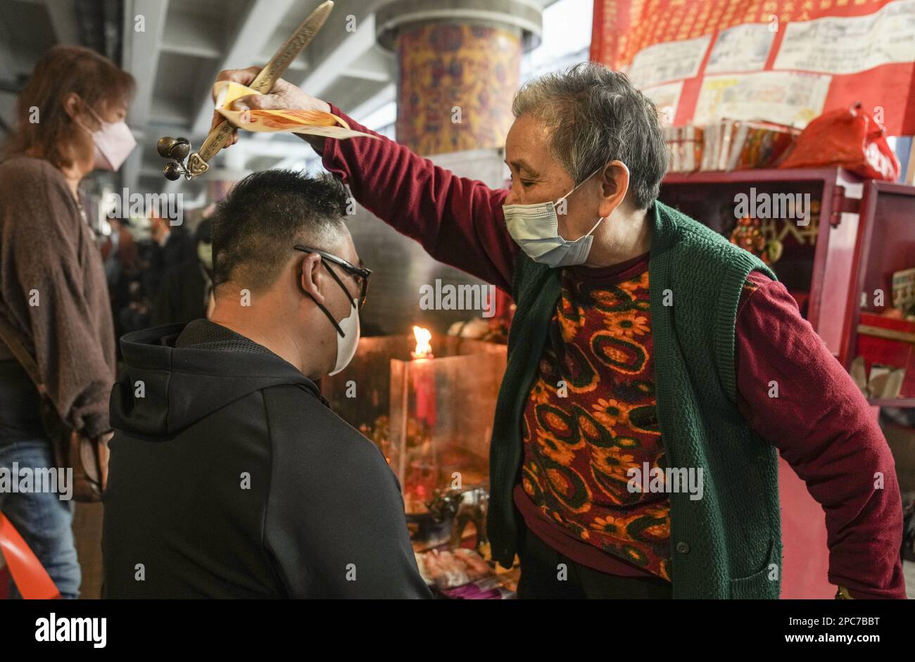 People perform a 'villain hitting' ceremony under the Canal Road ...