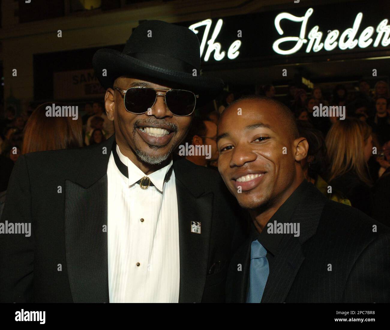 Former Marshall quarterback Reggie Oliver, left, poses for a photo with ...