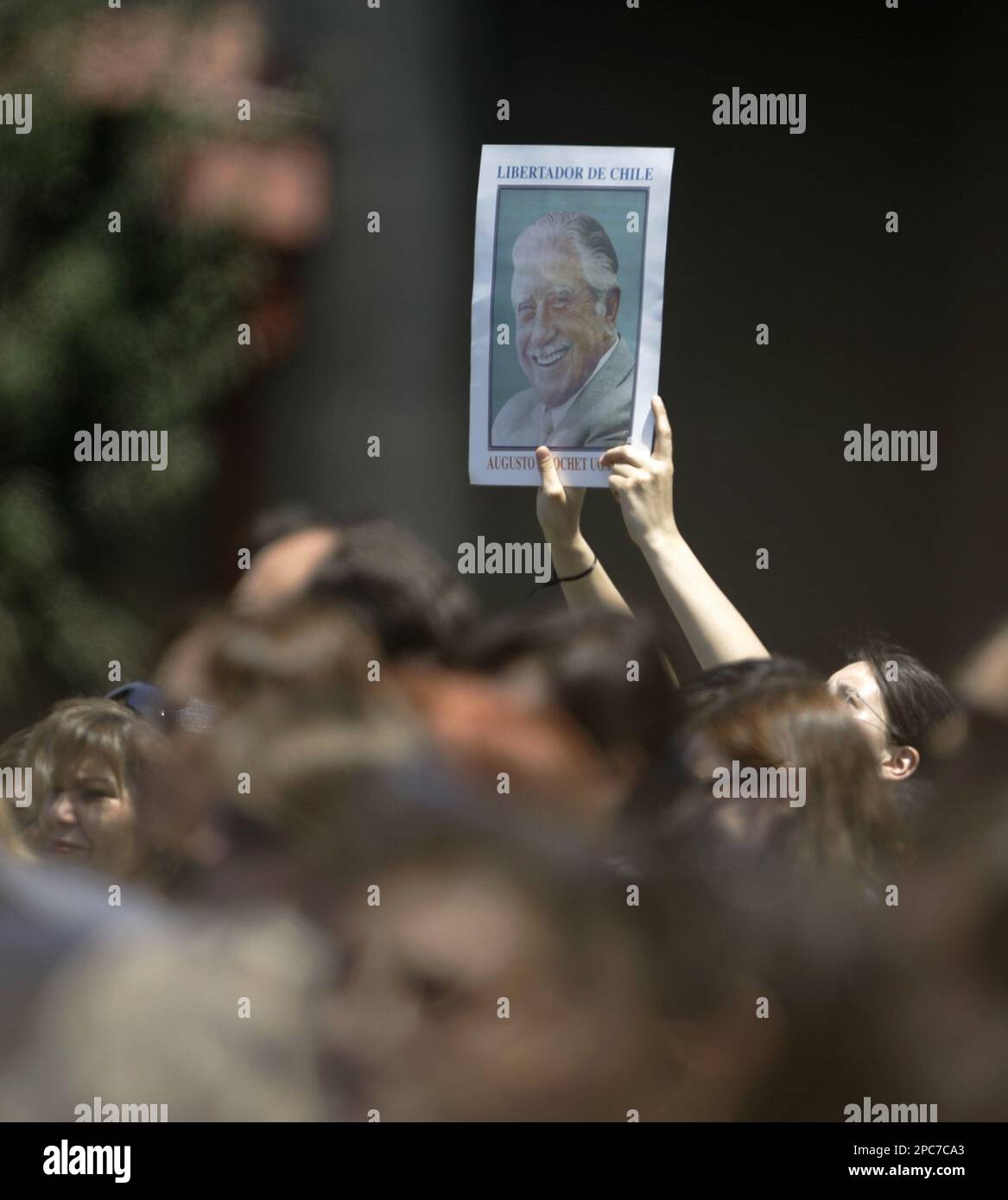 A supporter of former military ruler Gen. Augusto Pinochet hold his ...