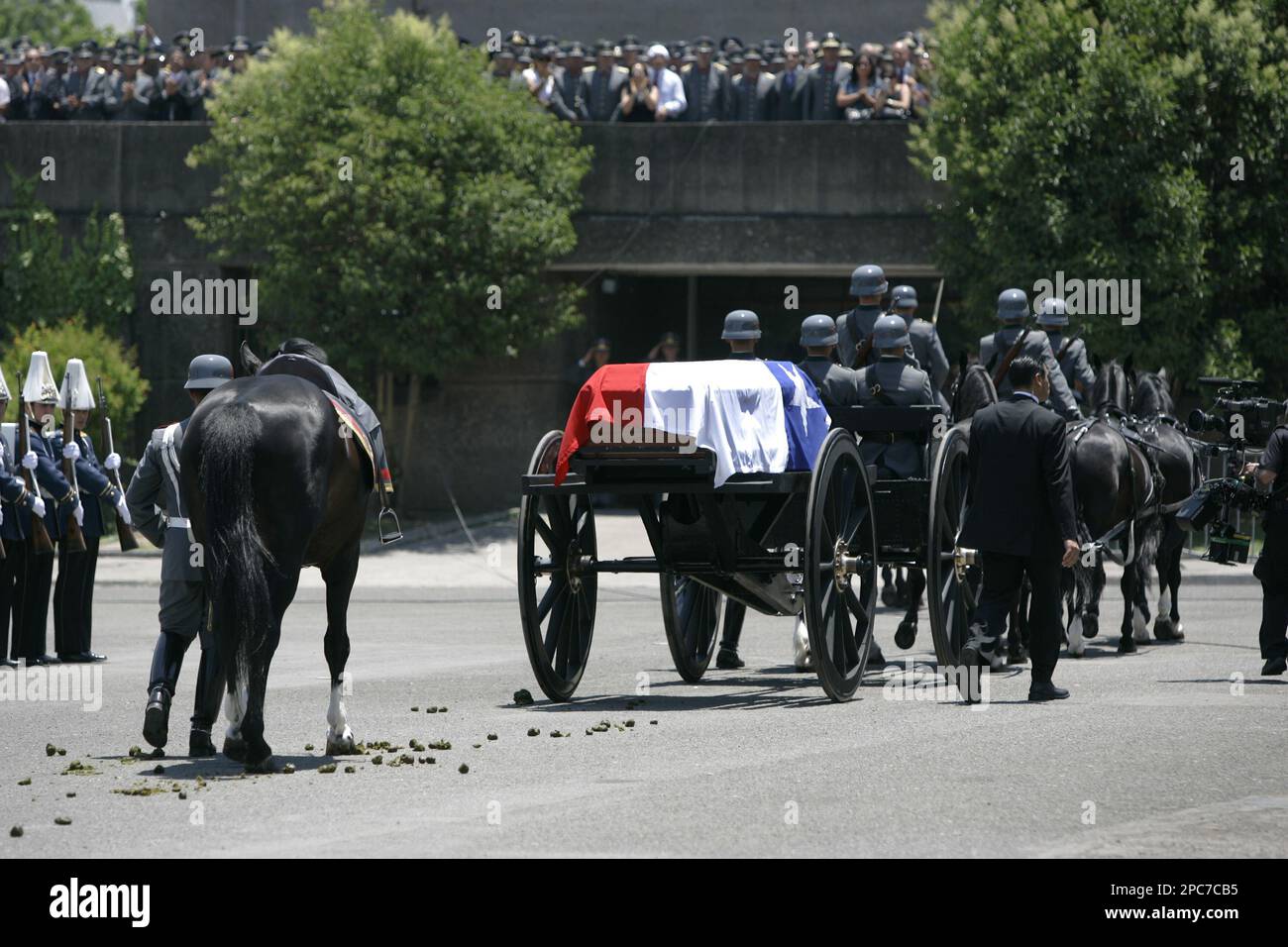 A horse is guided by a soldier following the casket with the remains of ...