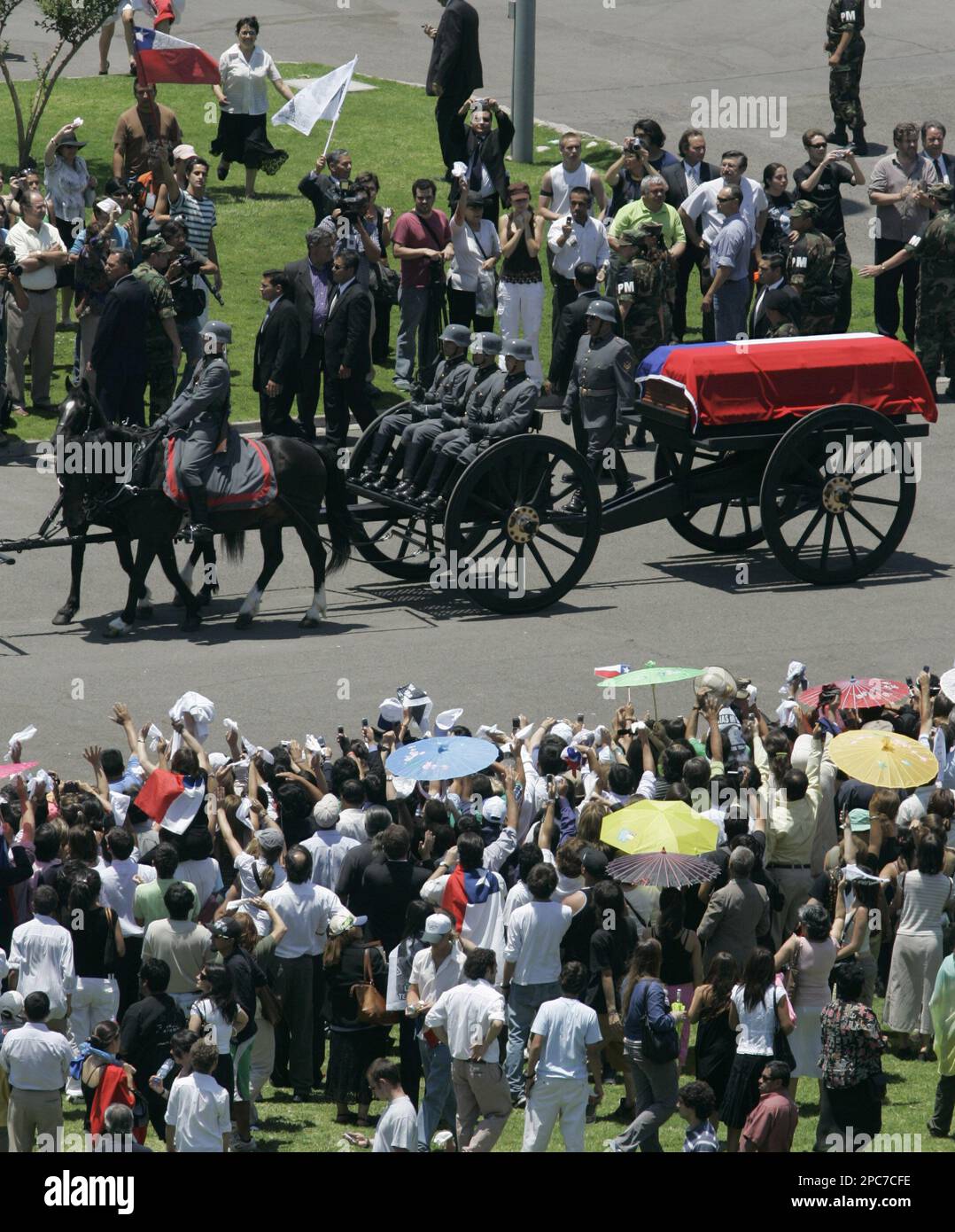 Supporters wave as the casket with the remains of former military ruler ...