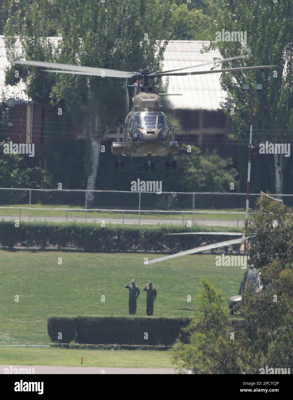 Two officers salute as the helicopter carrying the coffin of former ...