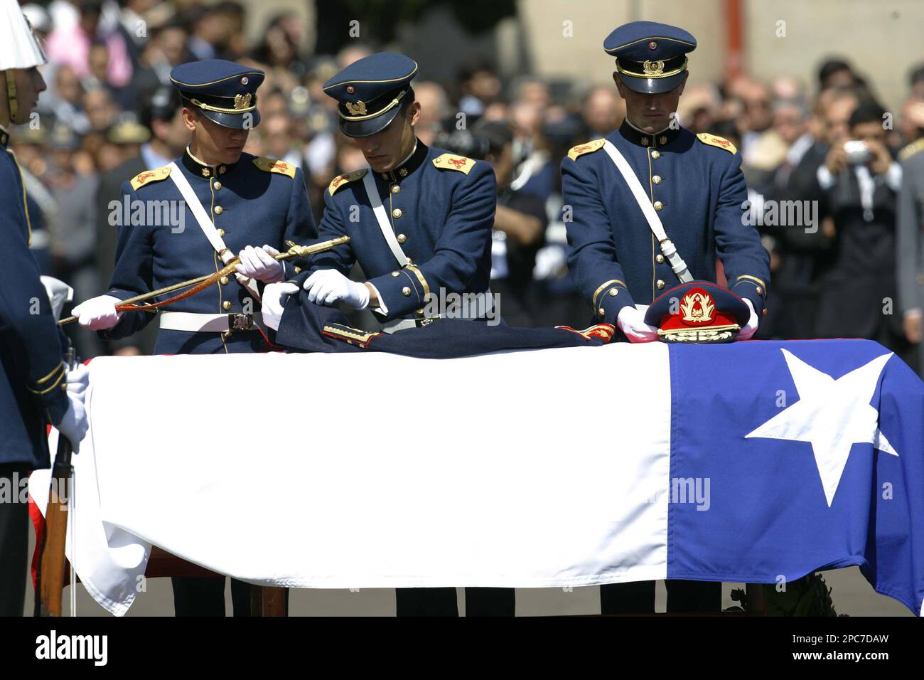 Honor Guard soldiers place the sword and the hat of former military ...