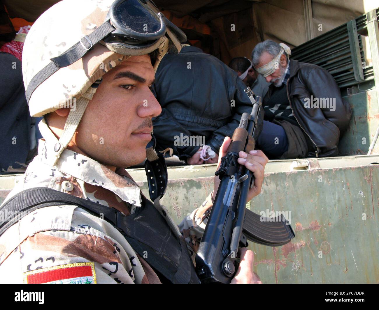 An Iraqi army soldier guards detainees in an army base in Baqouba, 60 ...