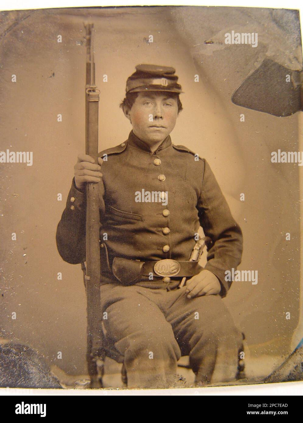 Unidentified young soldier in Union uniform with musket, revolver, and ...