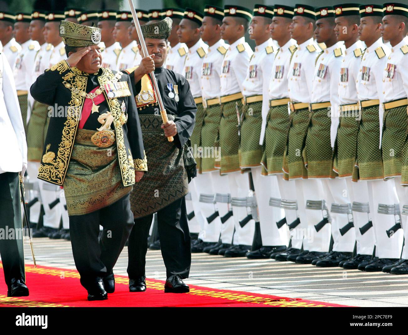Malaysian King Syed Sirajuddin Syed Putra Jamalullail salutes, left ...