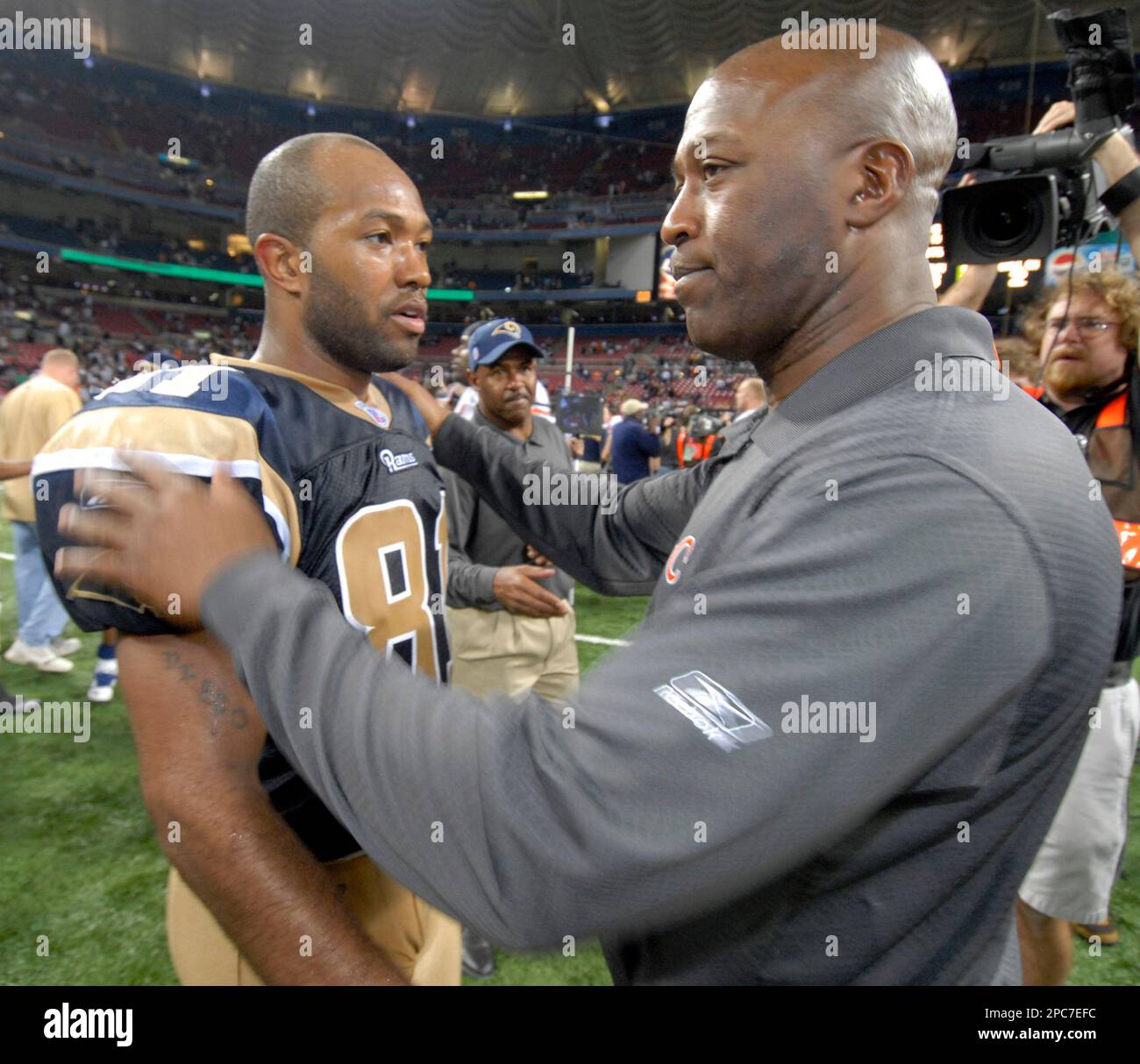 Chicago Bears head coach Lovie Smith greets St. Louis Rams' Torry Holt ...