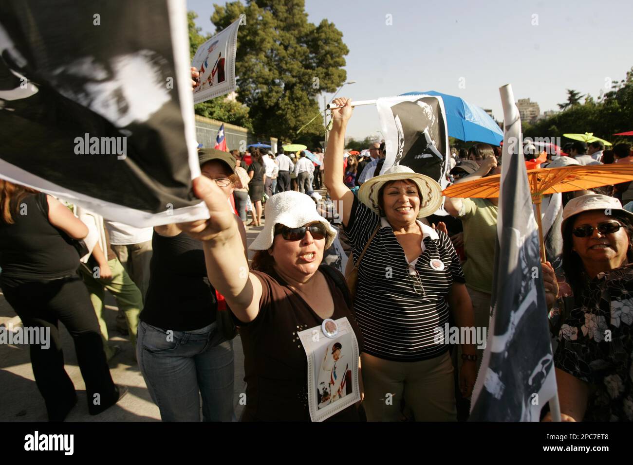 Supporters of former military ruler Gen. Augusto Pinochet wave his ...