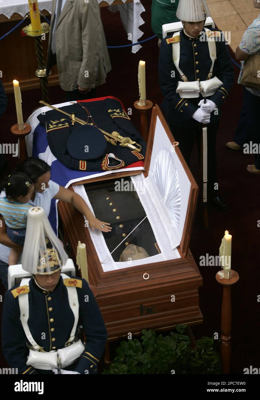 Supporters of former military ruler Gen Augusto Pinochet touch Pinochet ...