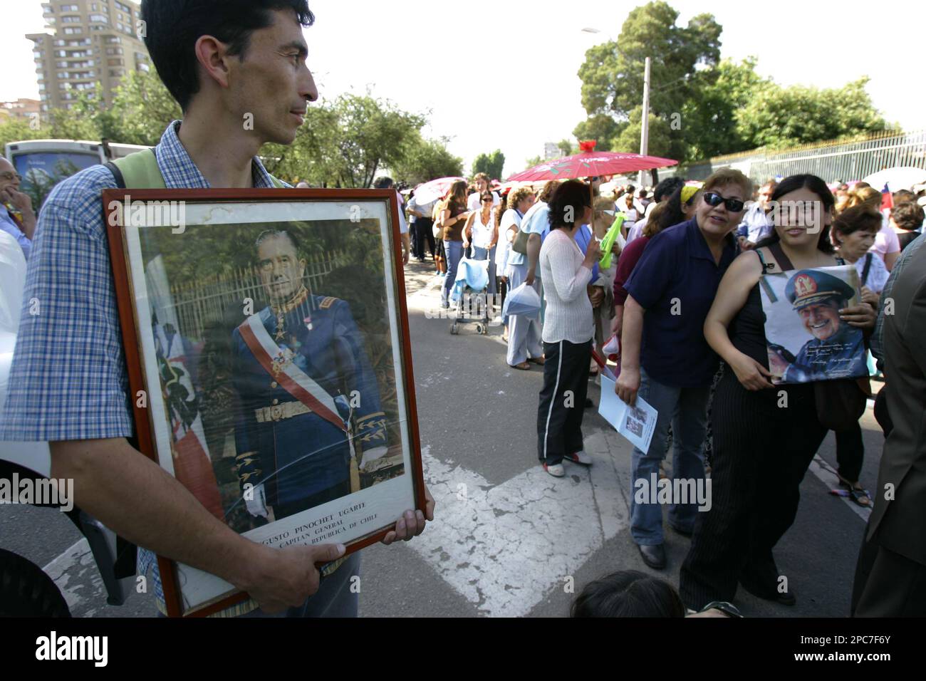 Supporters of former military ruler Gen. Augusto Pinochet hold his ...