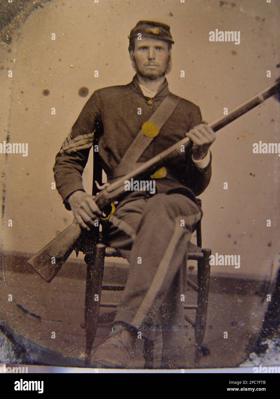 Unidentified soldier in Union sergeant's uniform sitting on a chair and ...