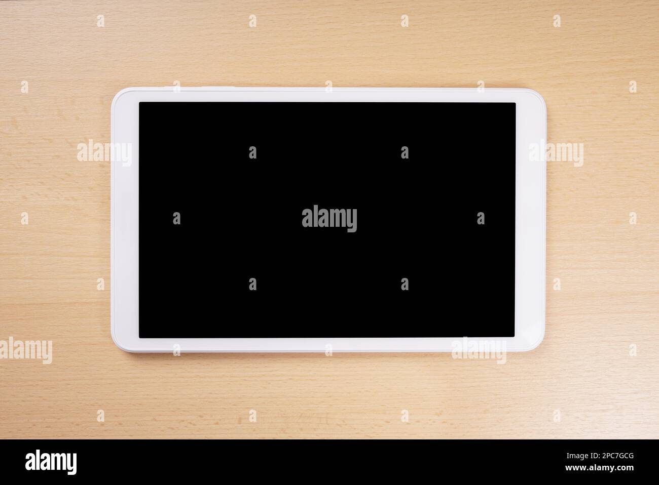 tablet computer with blank display lying on wooden desk Stock Photo - Alamy