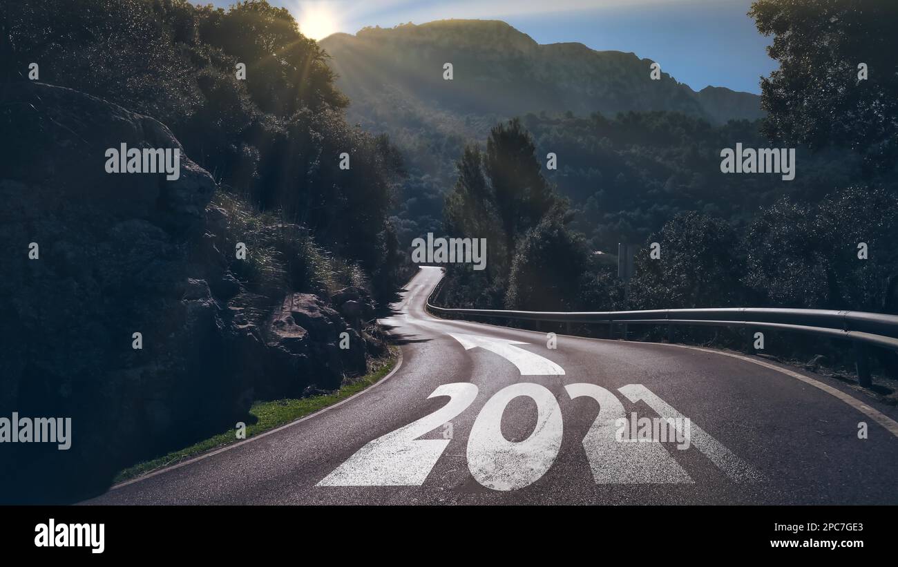 year 2021 and arrow on long winding road, moving on to new year concept ...