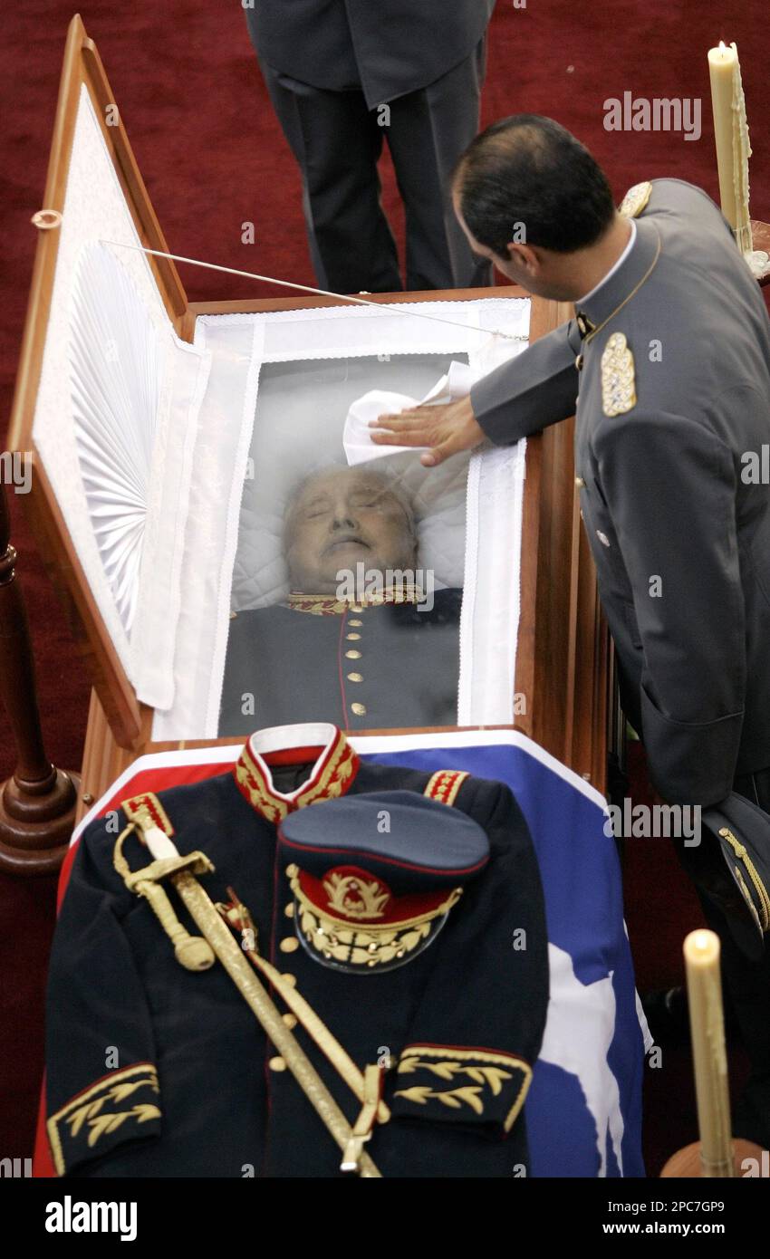 A military officer wipes the coffin of former military ruler Gen ...