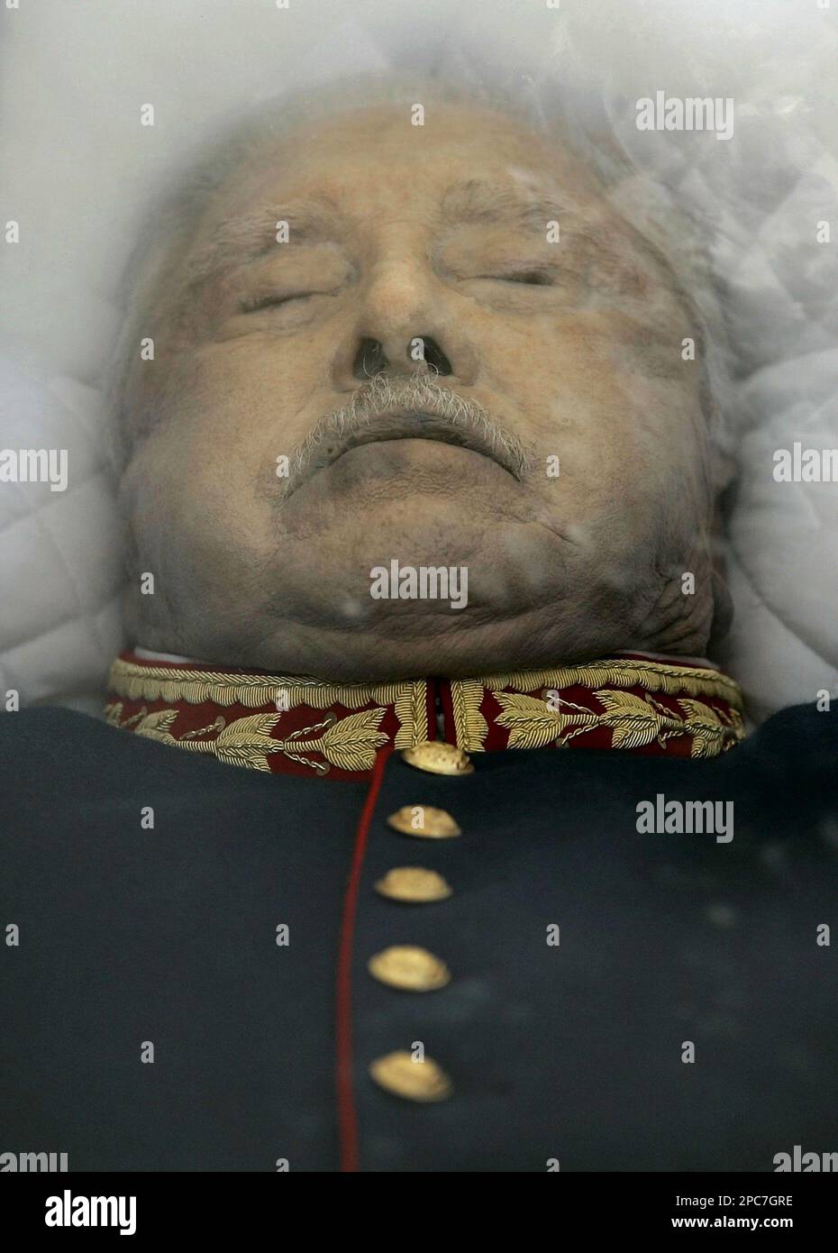 Former military ruler Gen. Augusto Pinochet is seen inside a coffin ...