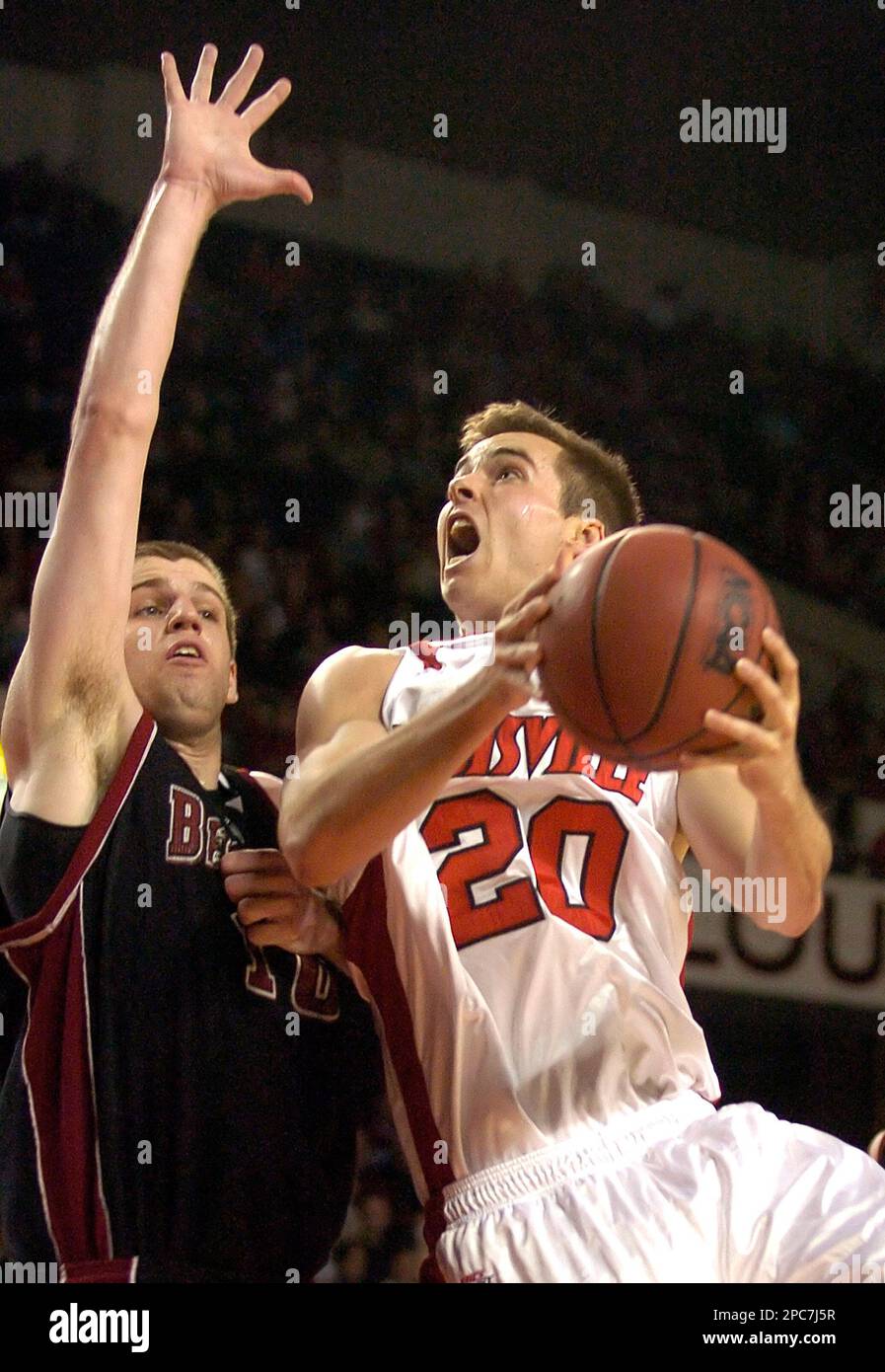 Louisville's Will Scott, right, drives to the basket against the ...