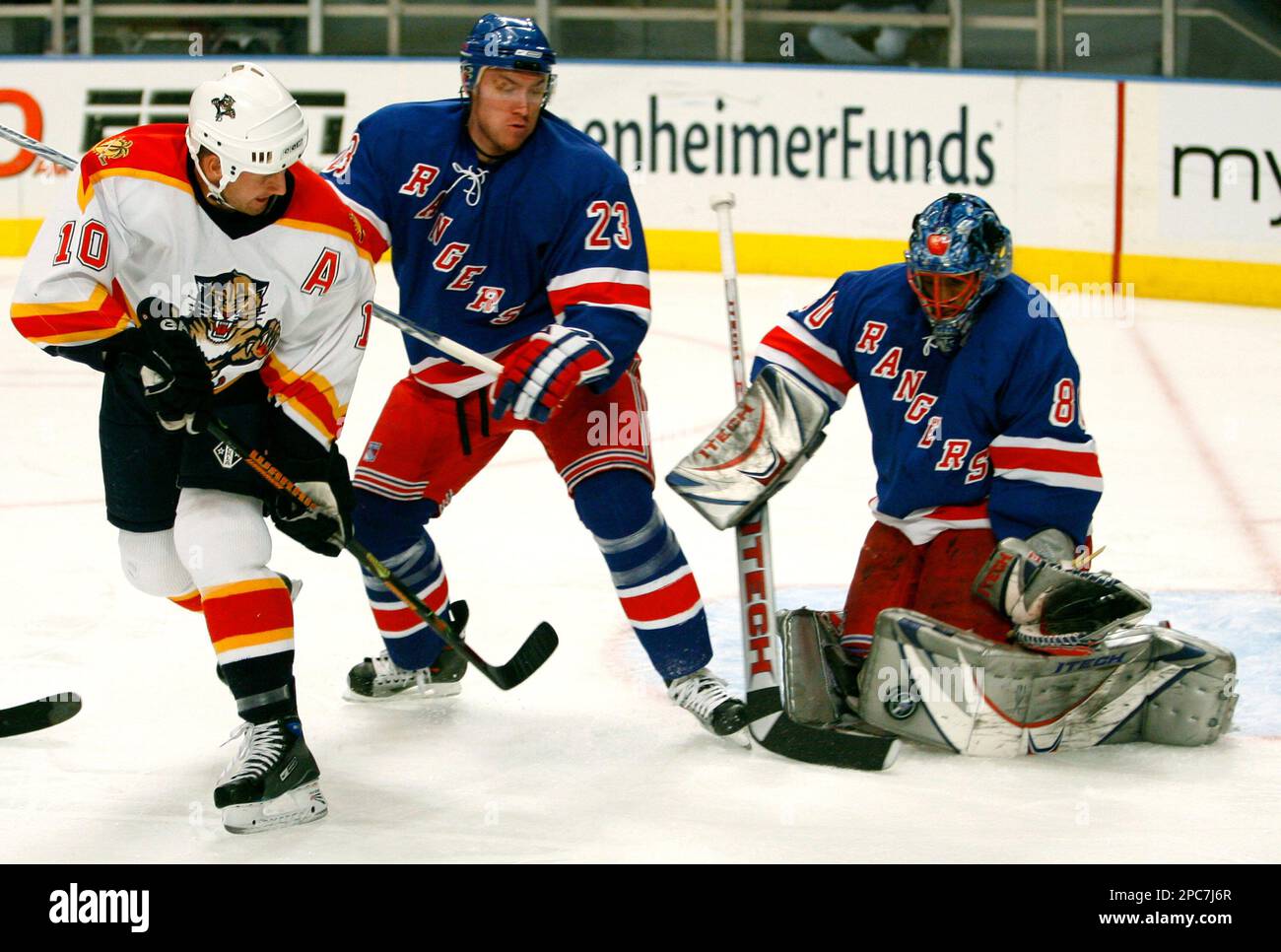New York Rangers goalkeeper Kevin Weekes, right, makes a save on a shot ...
