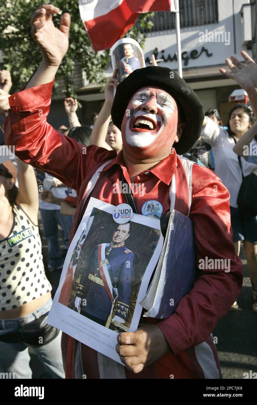 A supporter of former Gen. Augusto Pinochet holds a portrait as he ...