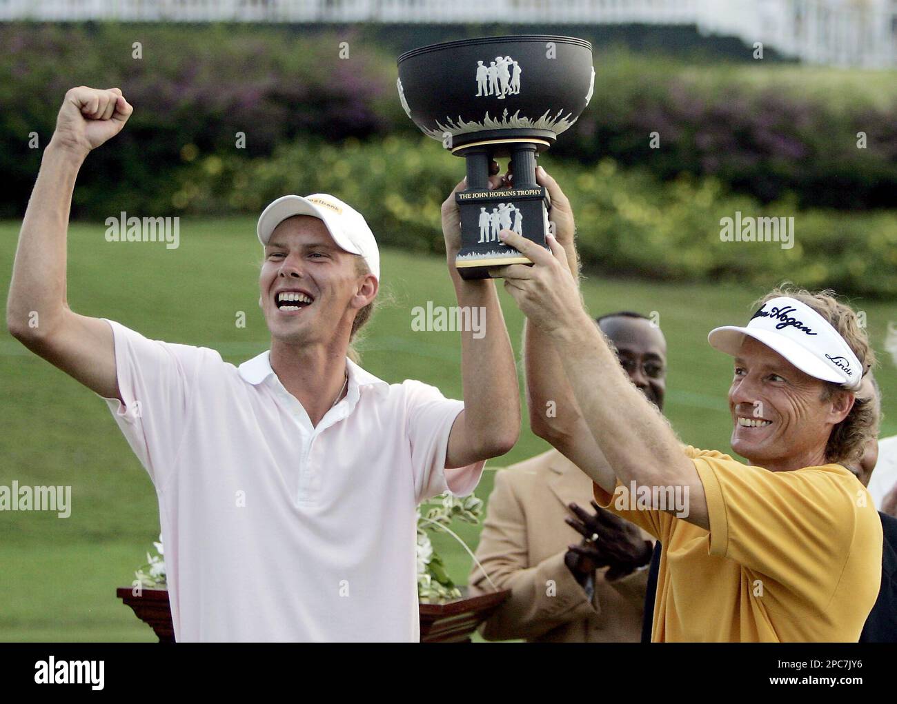 Germany's Marcel Siem, left, and his teammate Bernhard Langer hold up ...