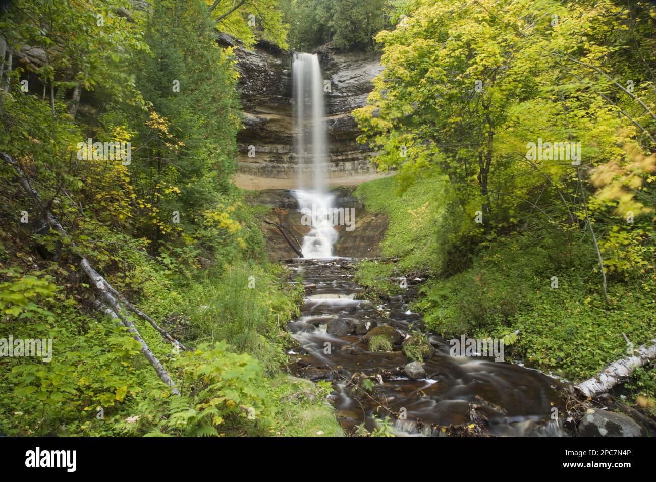 Waterfall flowing over a sandstone cliff, Munising Falls, Munising ...