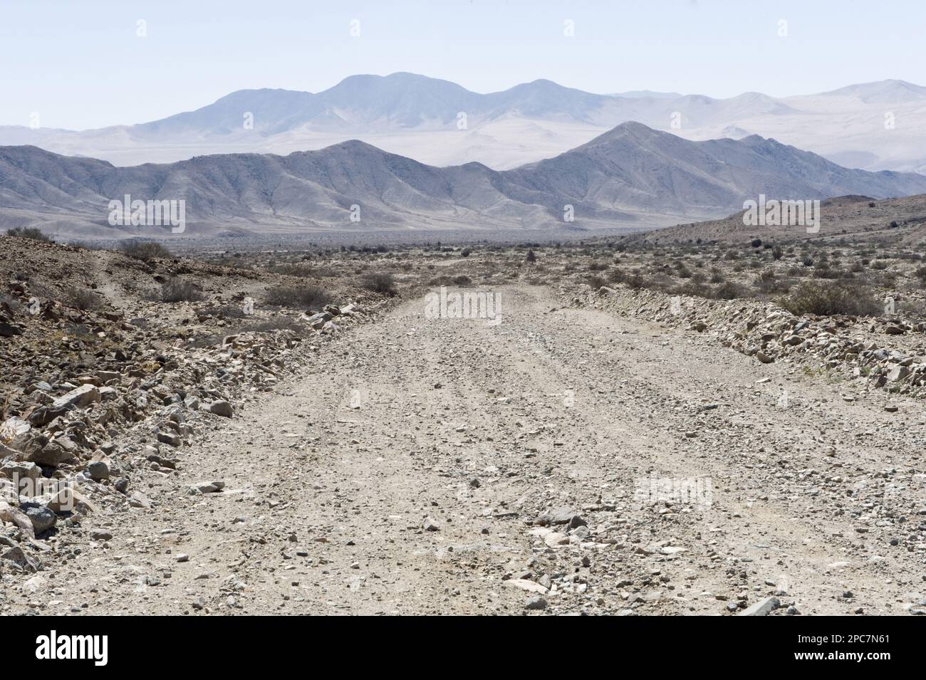 View of the road through stony desert, Sierra Monardes Mountains ...