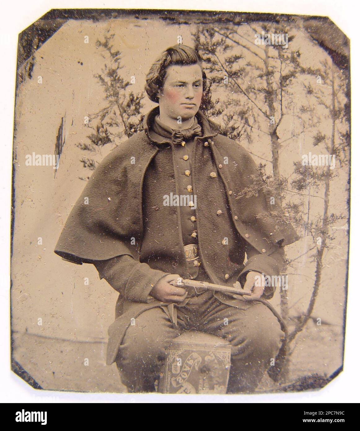 Unidentified soldier in Union uniform and greatcoat holding handgun ...