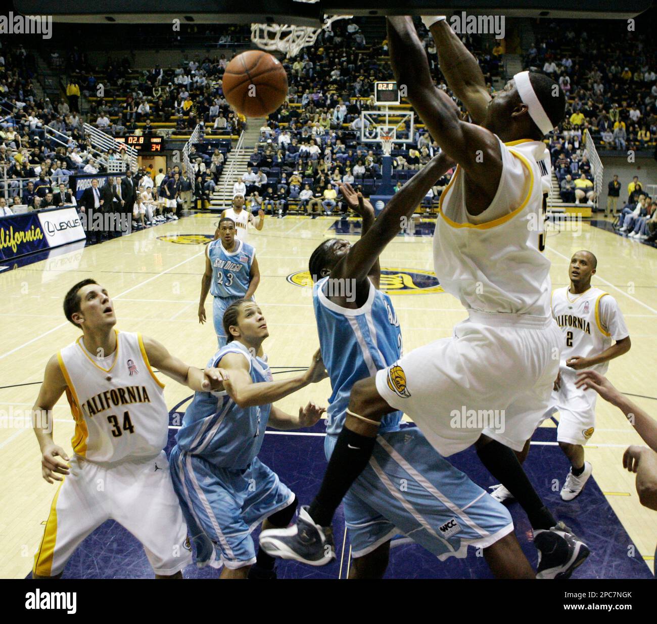 California's DeVon Hardin, right, dunks over San Diego's Gyno Pomare ...