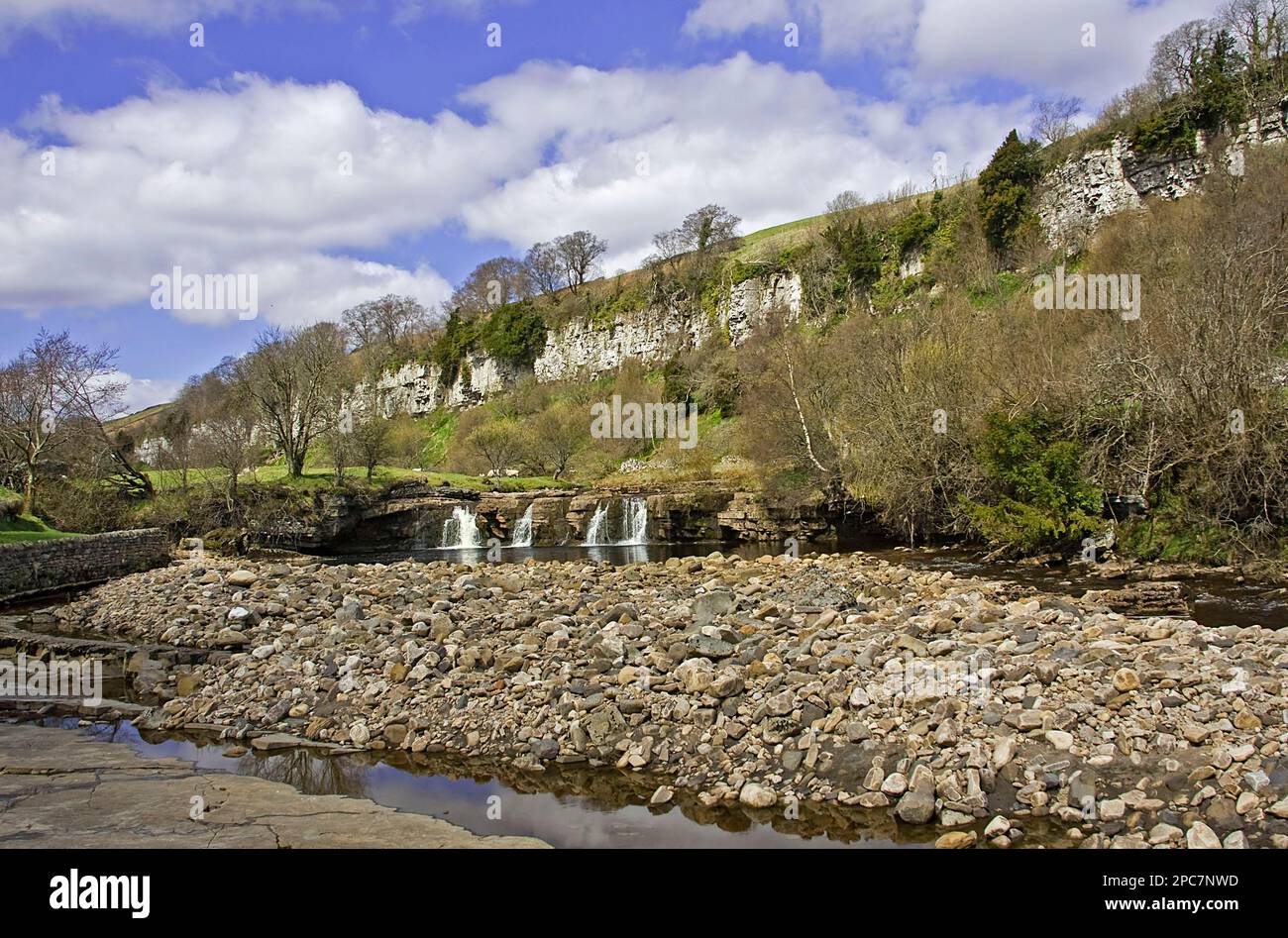 View of a river with waterfalls and limestone cliffs Wainwath Force and ...