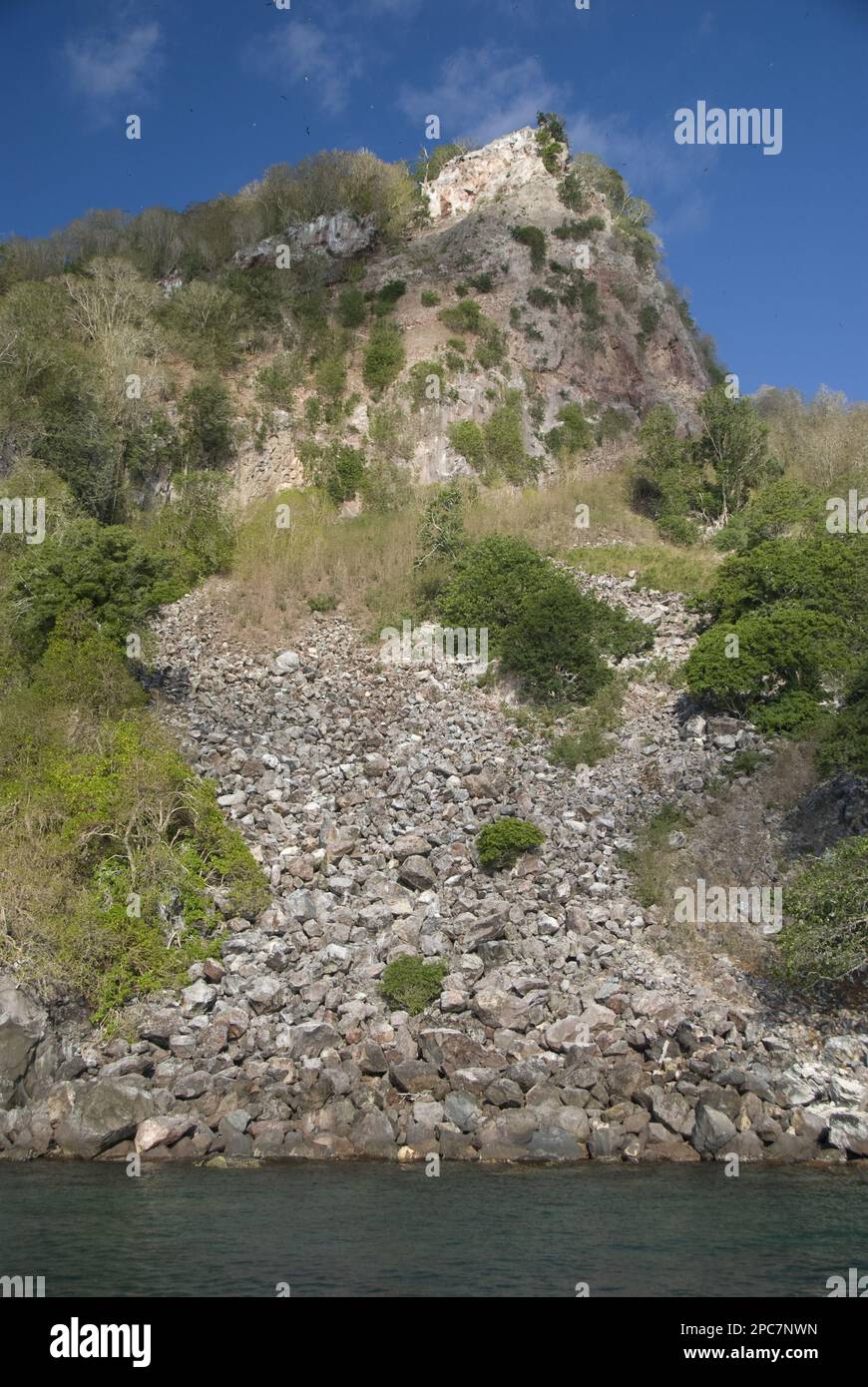 Rocky beach, scree slope and cliff on volcanic mountain, Gunung Api ...