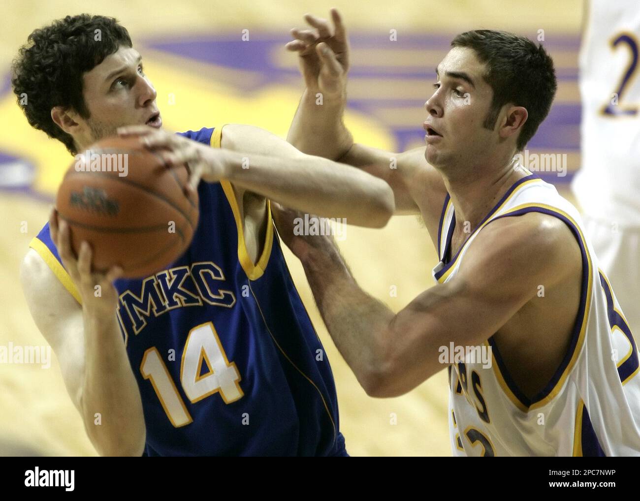 Missouri-Kansas City's Alex Pledger, left, drives to the basket as ...