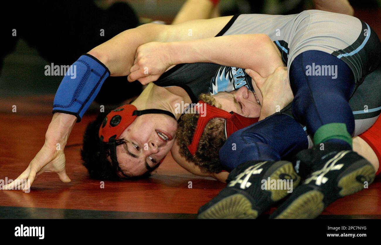 Hutchison's Joseph Heath, left, works to pin Wrangell's Dave Brown ...