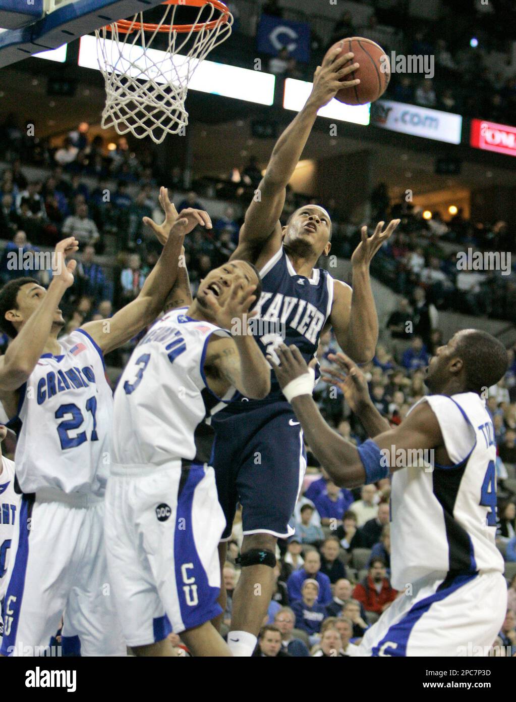Xavier's Justin Cage (3) shoots against Creighton's Ty Morrison, left ...