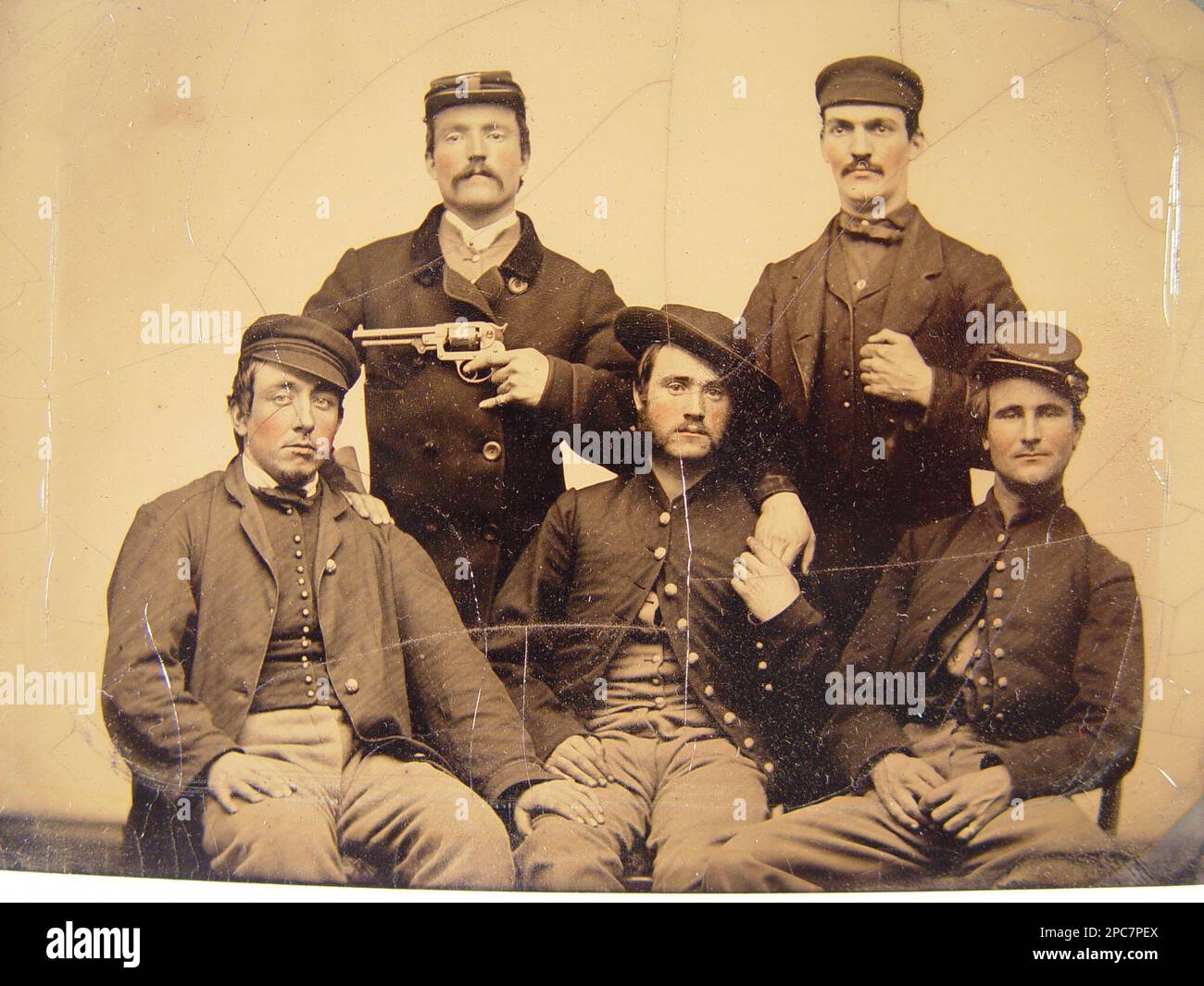 Three unidentified men in Union uniforms and two unidentified men, one pointing a Starr revolver ...
