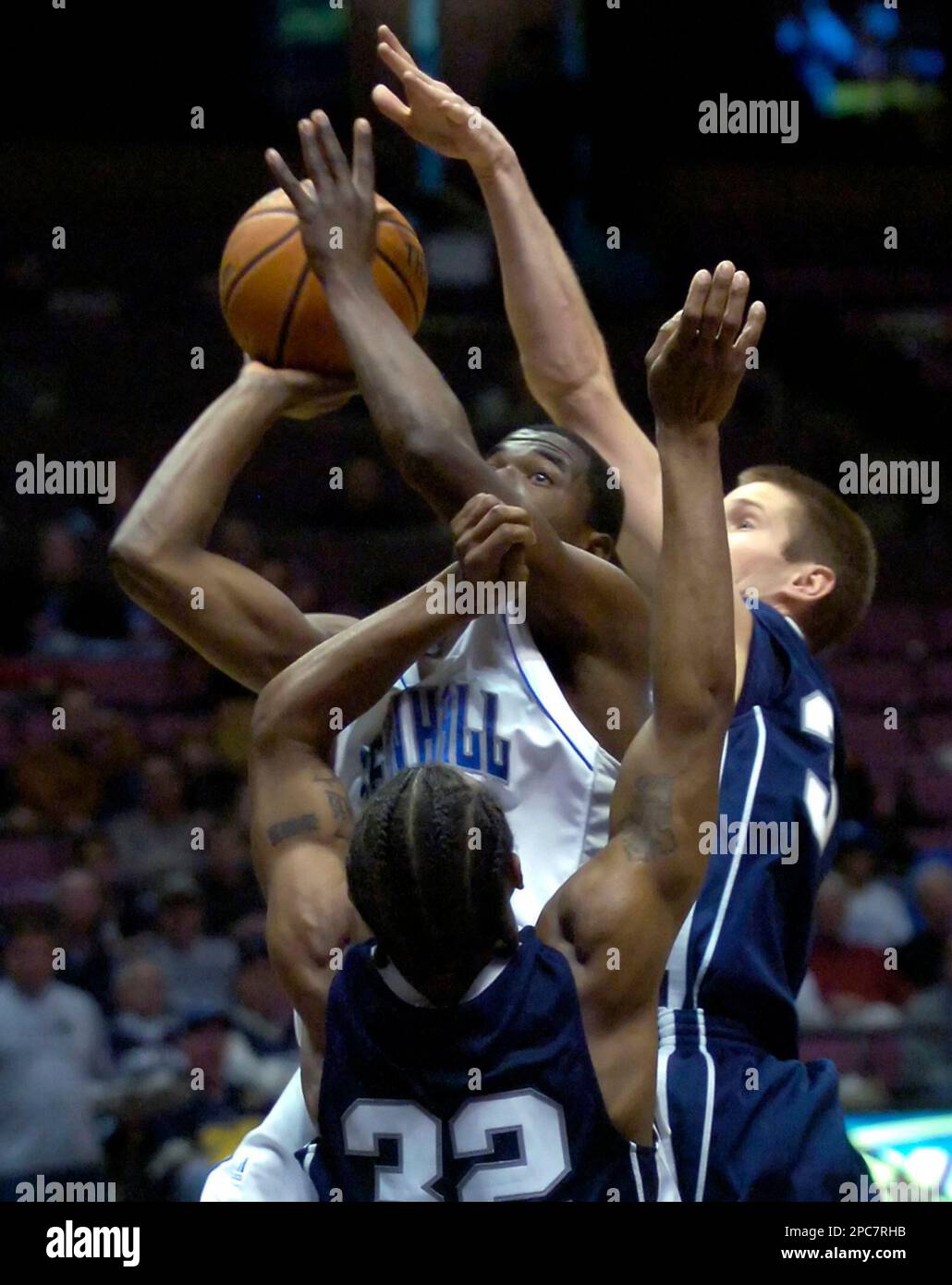 Seton Hall's Eugene Harvey goes up for a shot as he is double-teamed by ...
